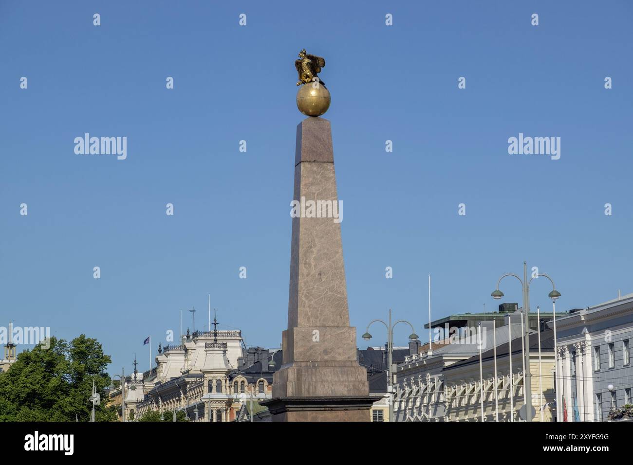Large obelisk with a golden ball and sculpture at the top, in front of ...