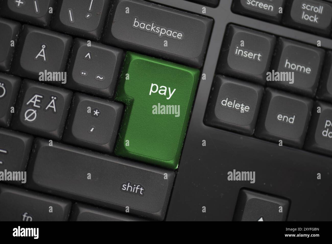 Computer keyboard with a green pay button Stock Photo - Alamy