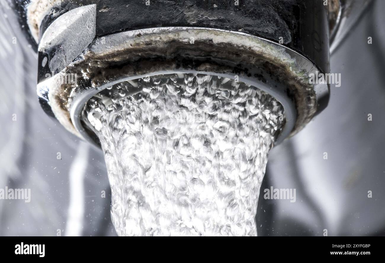 Water flows from a tap Stock Photo - Alamy