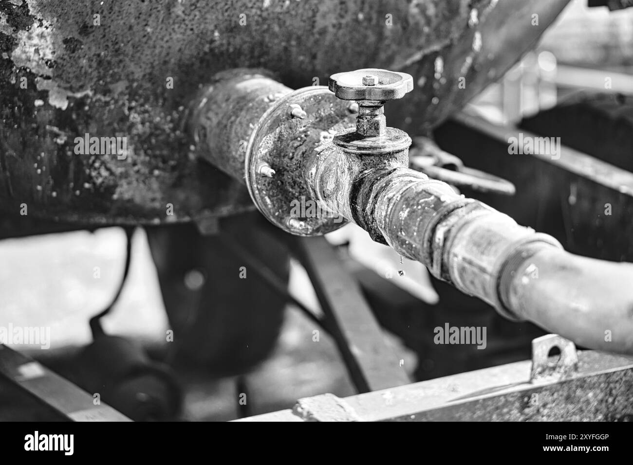 Dripping tap of a water tank in the open, Drops fall from the pipe ...