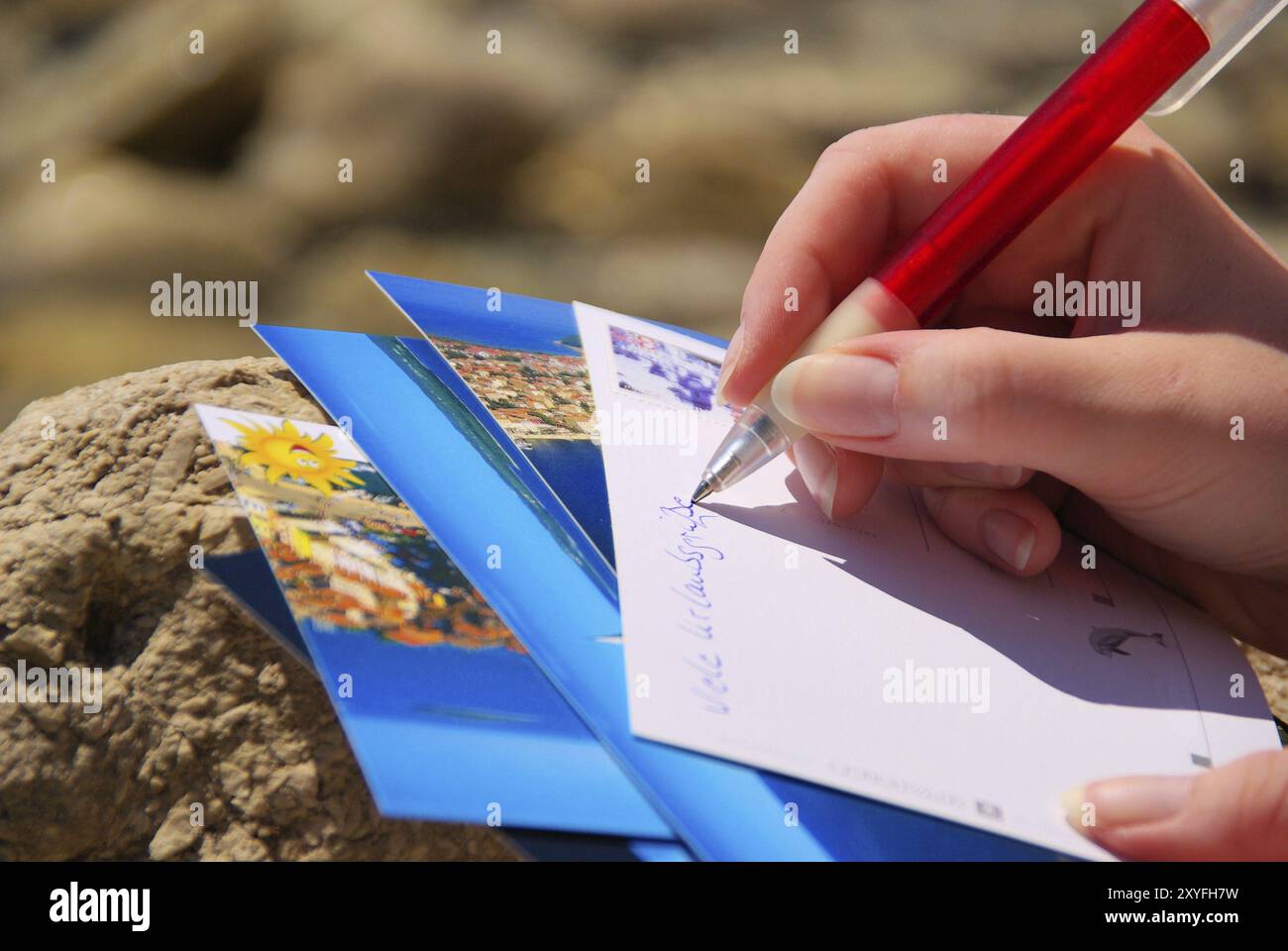 Postcard writing, writing a picture postcard Stock Photo - Alamy