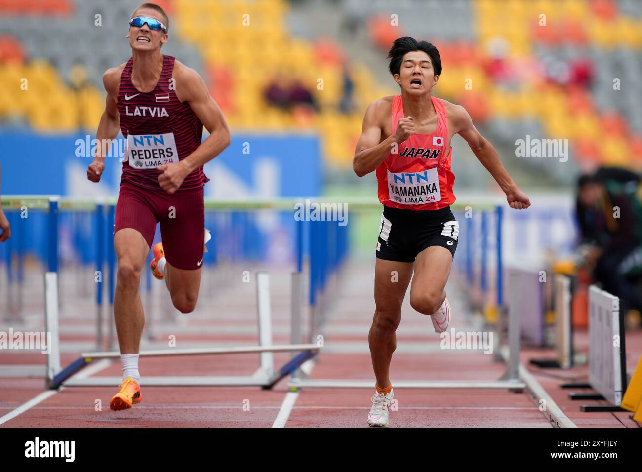 Japan's Kyousuke Yamanaka, right, competes in a men's 110-meter hurdles ...
