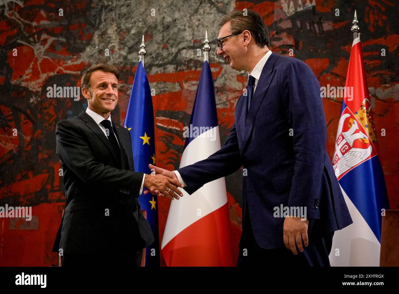 French President Emmanuel Macron, left, shakes hands with Serbian ...