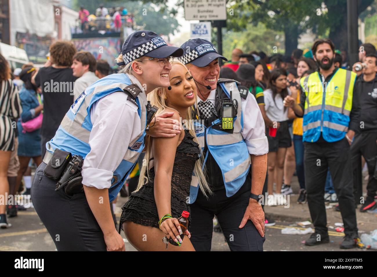 Woman performer poses for a photo with police officers during the Adult ...