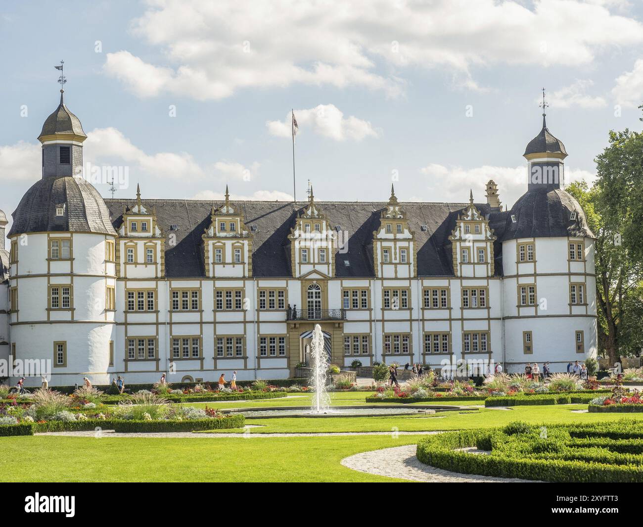 Magnificent baroque castle with a fountain and artistically trimmed ...
