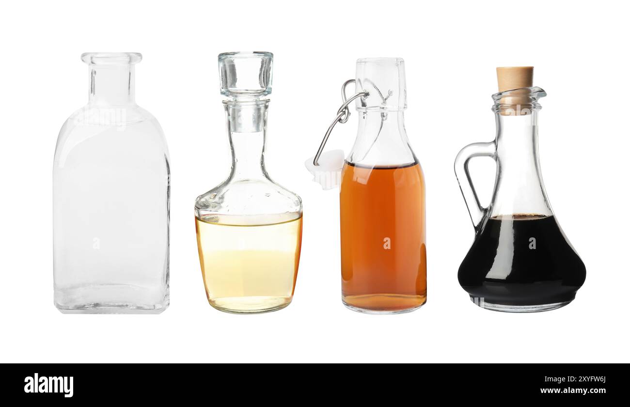 Different types of vinegar in glass bottles isolated on white, set ...