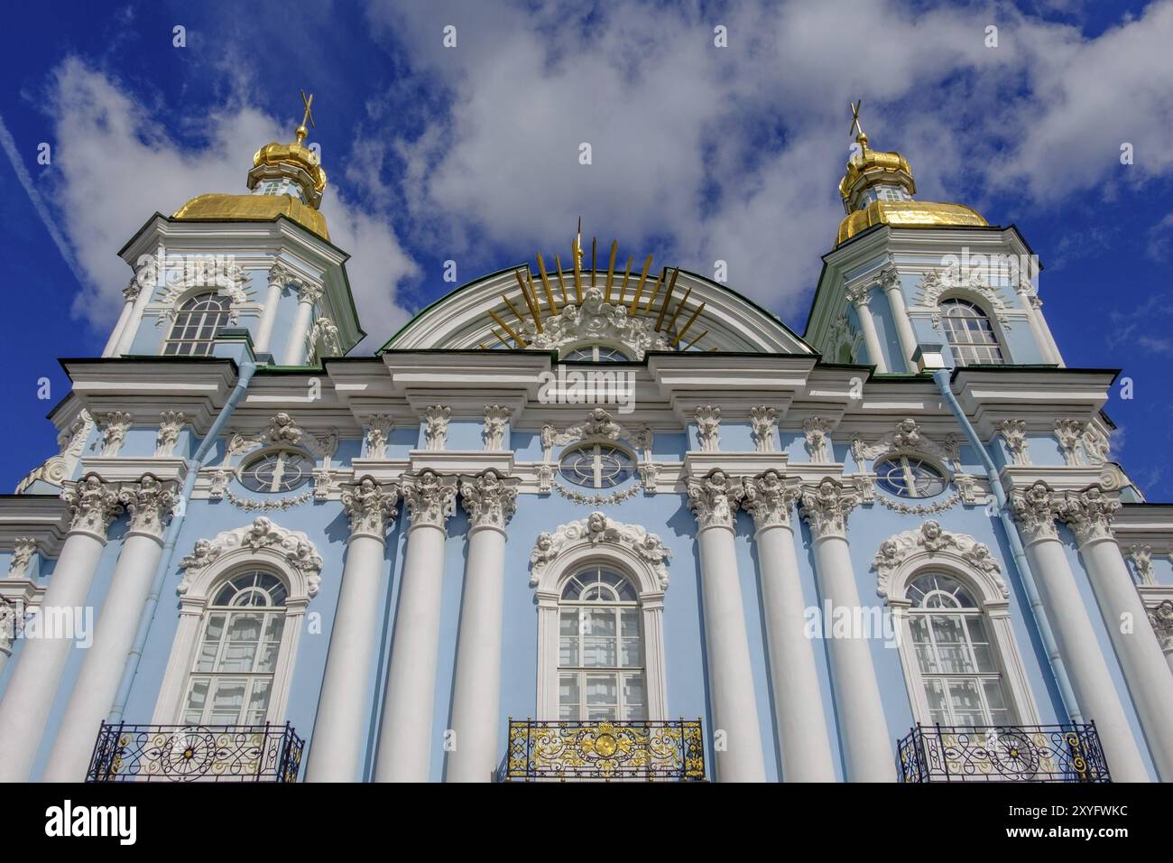 A magnificent church with golden domes, a blue facade and white columns ...
