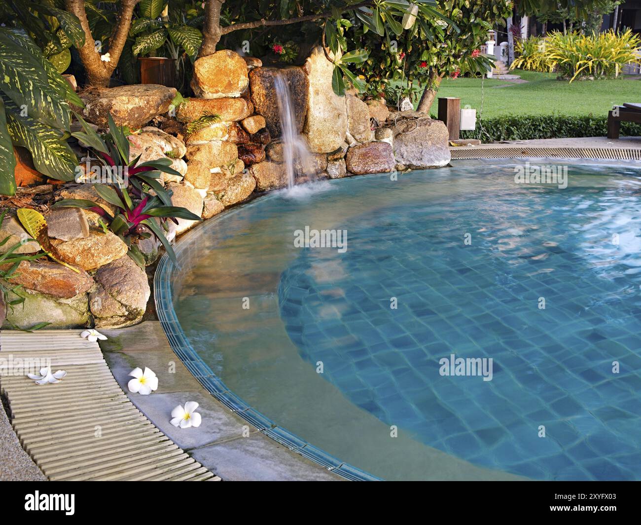Pool with a waterfall in a resort Stock Photo - Alamy