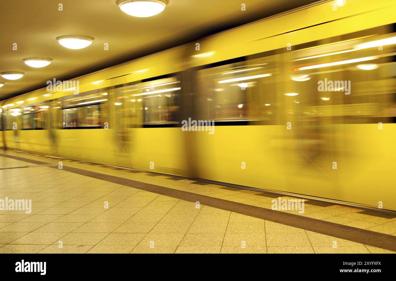 Yellow passing berlin metro train with motion blur Stock Photo - Alamy