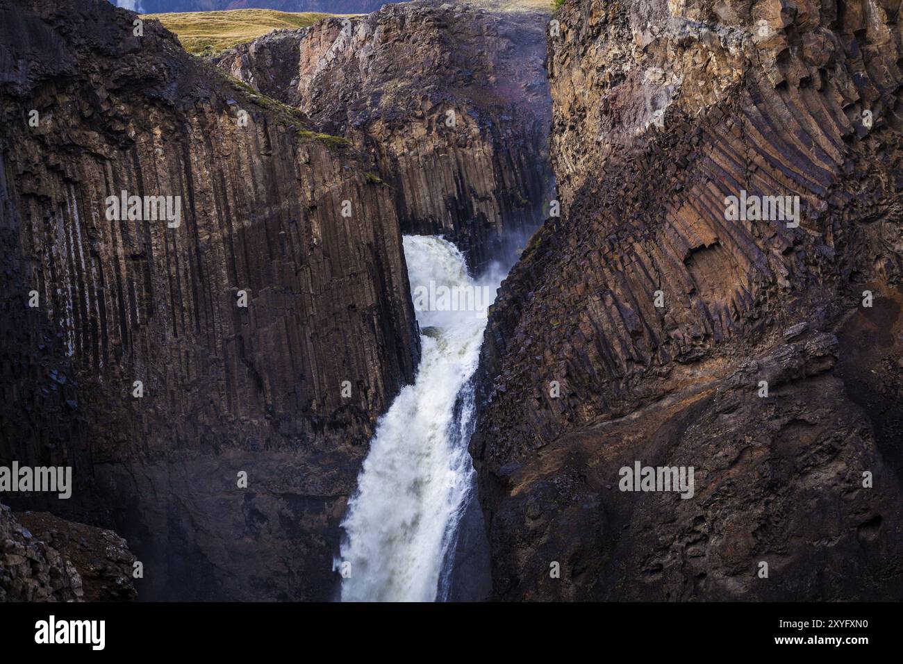 Waterfall gushing through volcanic rock on Iceland Stock Photo - Alamy
