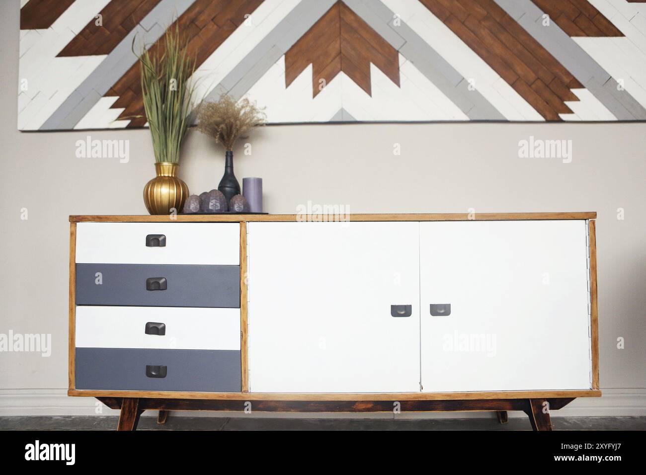 Part of the room interior with wooden commode, vintage vases and ...