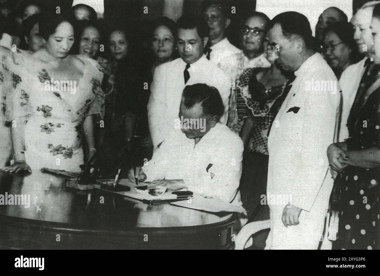 Philippine President Manuel L. Quezon signing the Women's Suffrage Bill ...