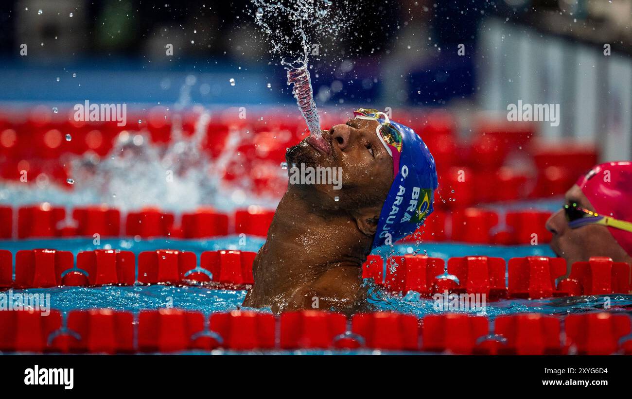 Paralympic athlete Araujo dos Santos, of Brasil, spits water to ...