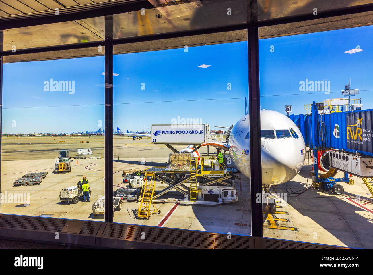 Commercial airplane at the gate undergoing catering service at an ...