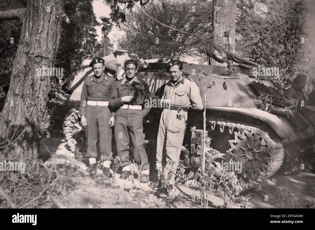 A crew of a Polish army light tank, known as the Stuart Recce, posing ...