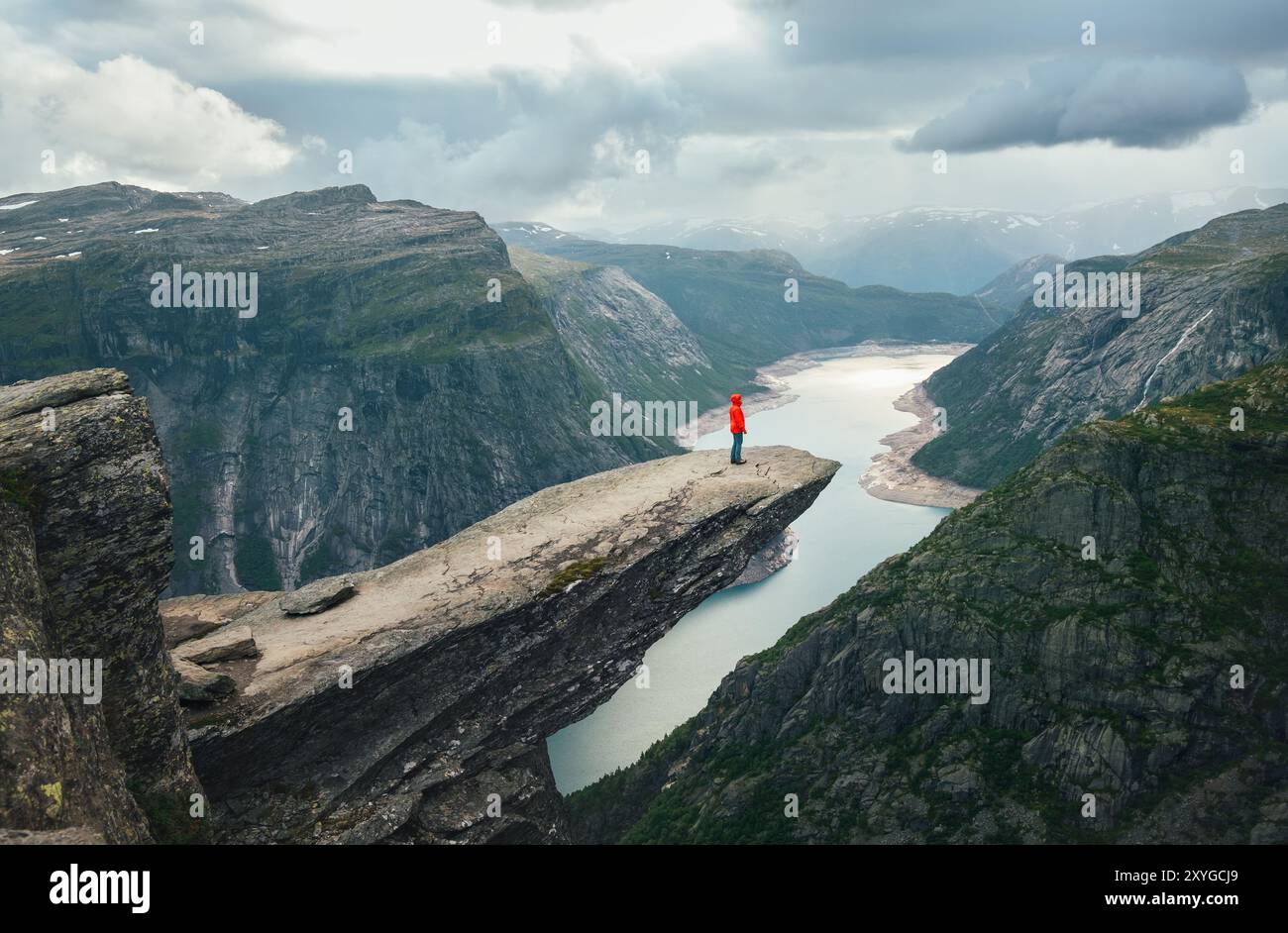 Woman trekker dressed bright red jacket enjoying glacier ...