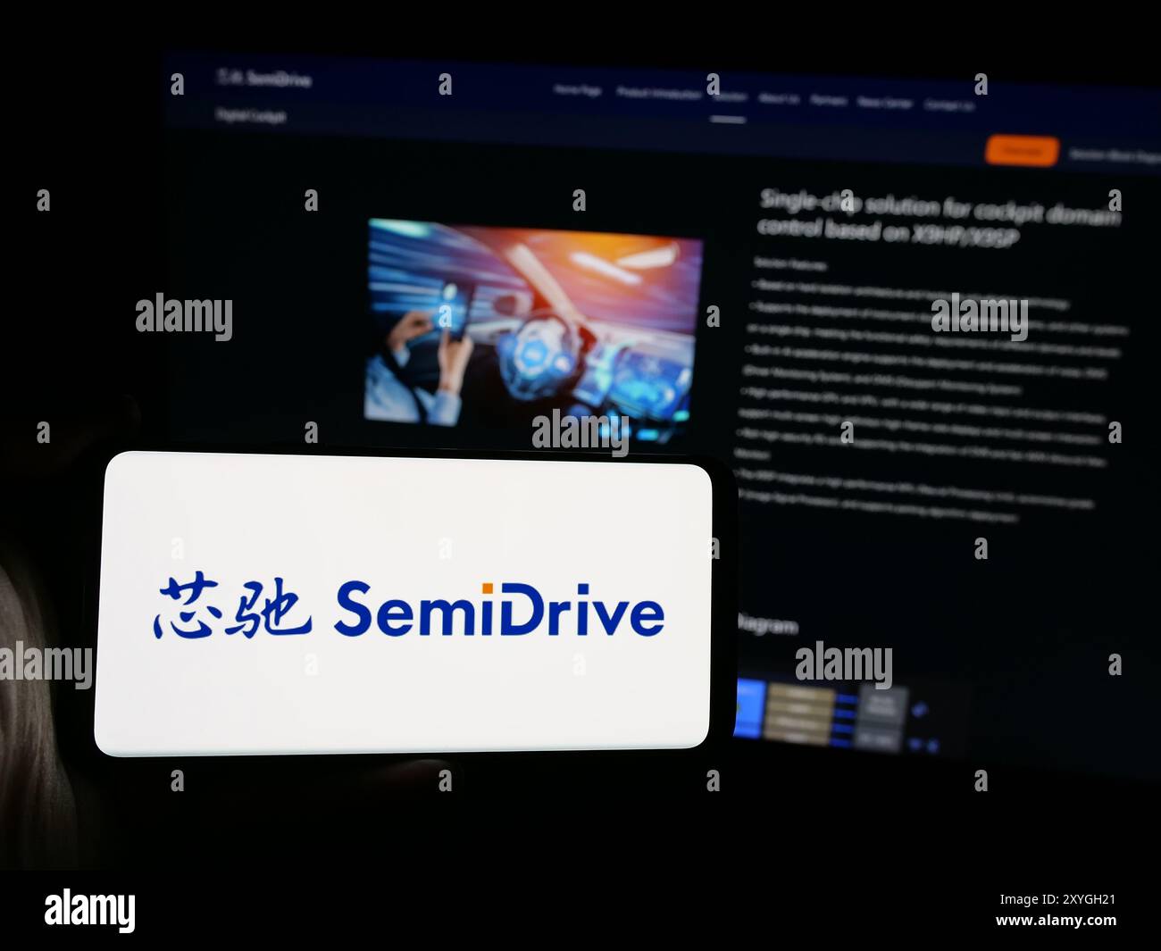 Person holding smartphone with logo of Chinese company Beijing SemiDrive Technology Corporation ...