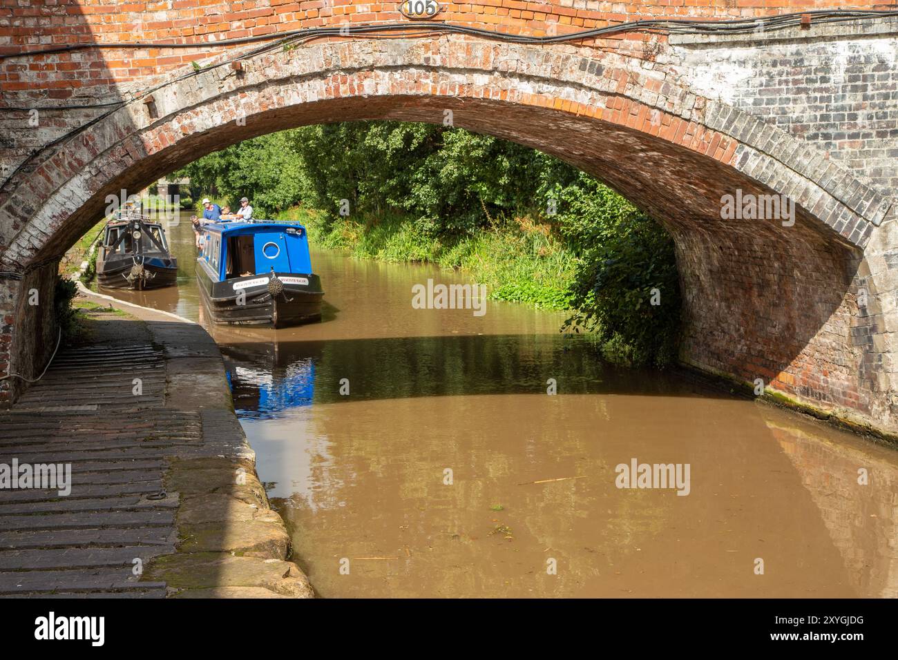 Canal narrowboat approaching Bunbury double staircase lock on the Shropshire Union canal ...