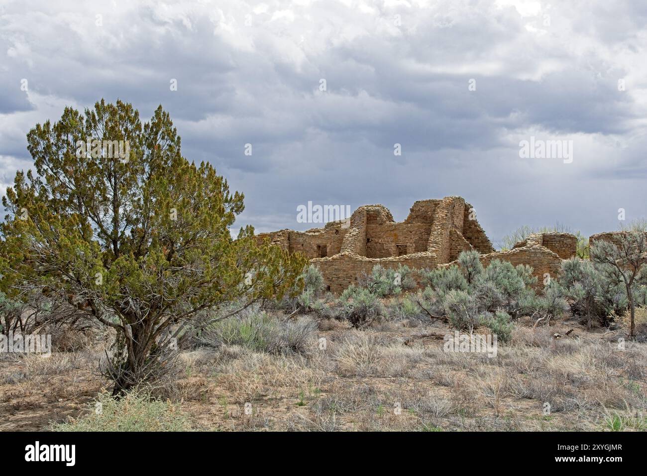 Stone masonry walls of ancient Puebloan great house under stormy sky of ...