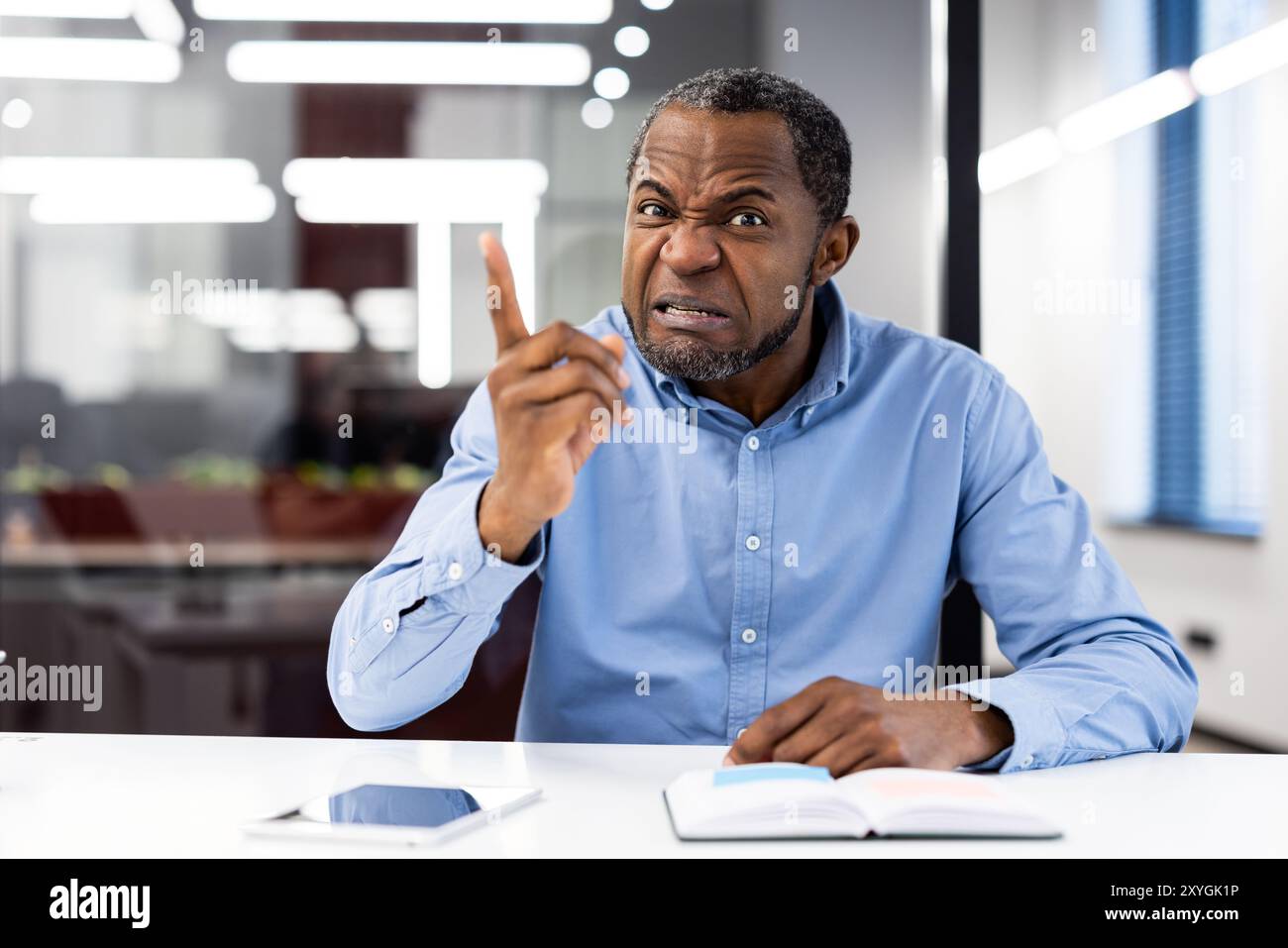 Frustrated businessman wearing blue shirt showing anger during video ...
