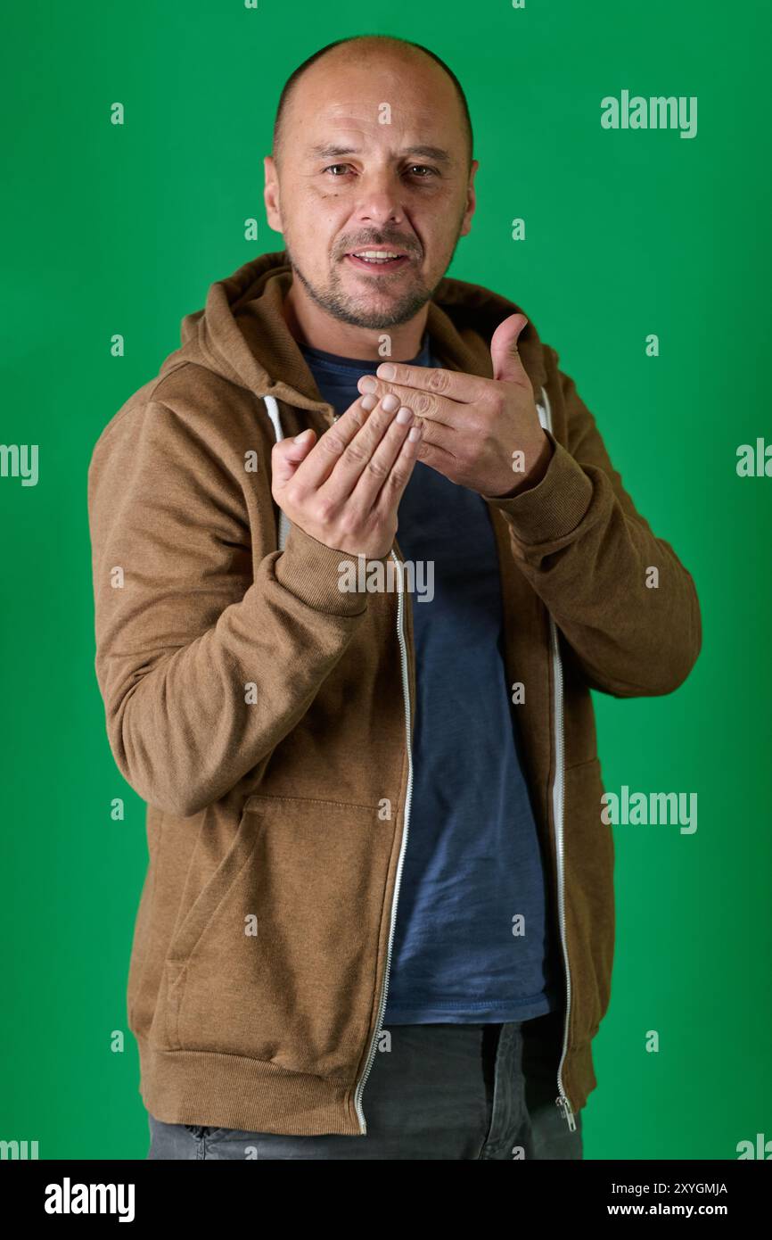 Middle aged bald man demonstrating composition techniques with hand ...