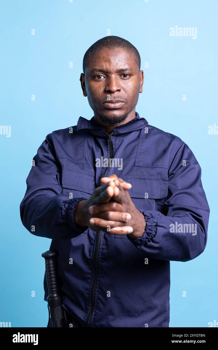 African american agent pointing an imaginary pistol in front of the ...