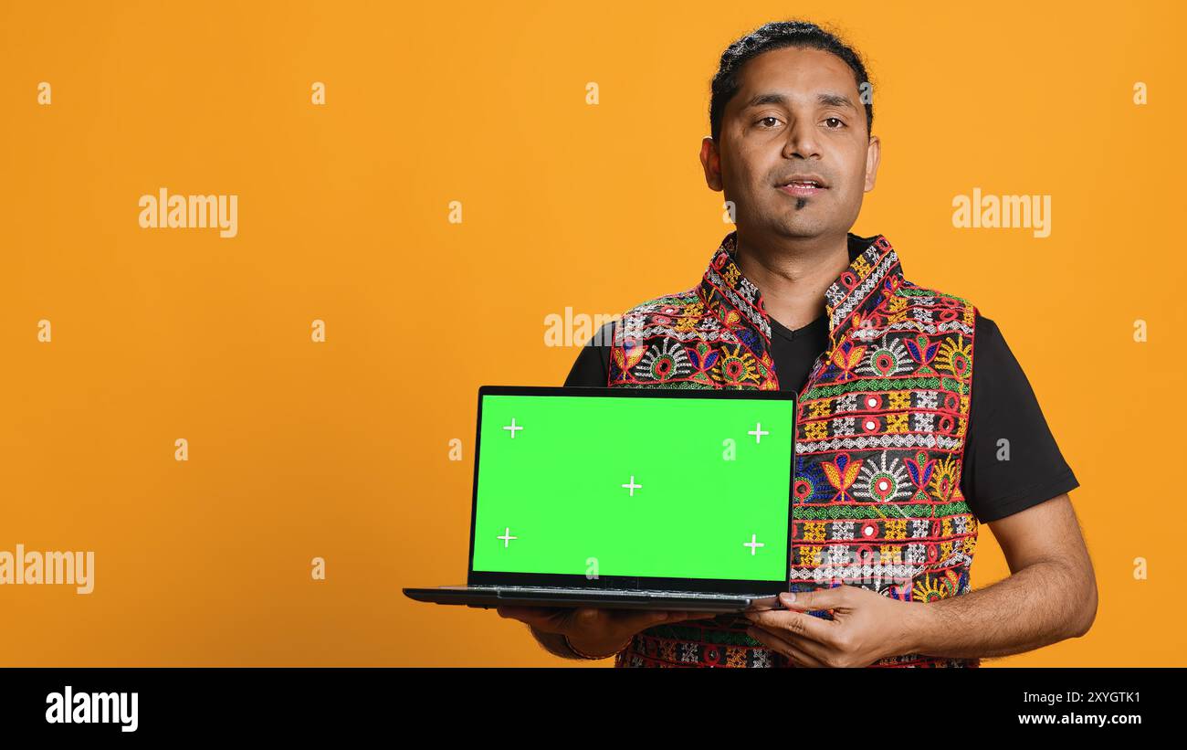 Upbeat tech specialist doing promotion using isolated screen laptop ...