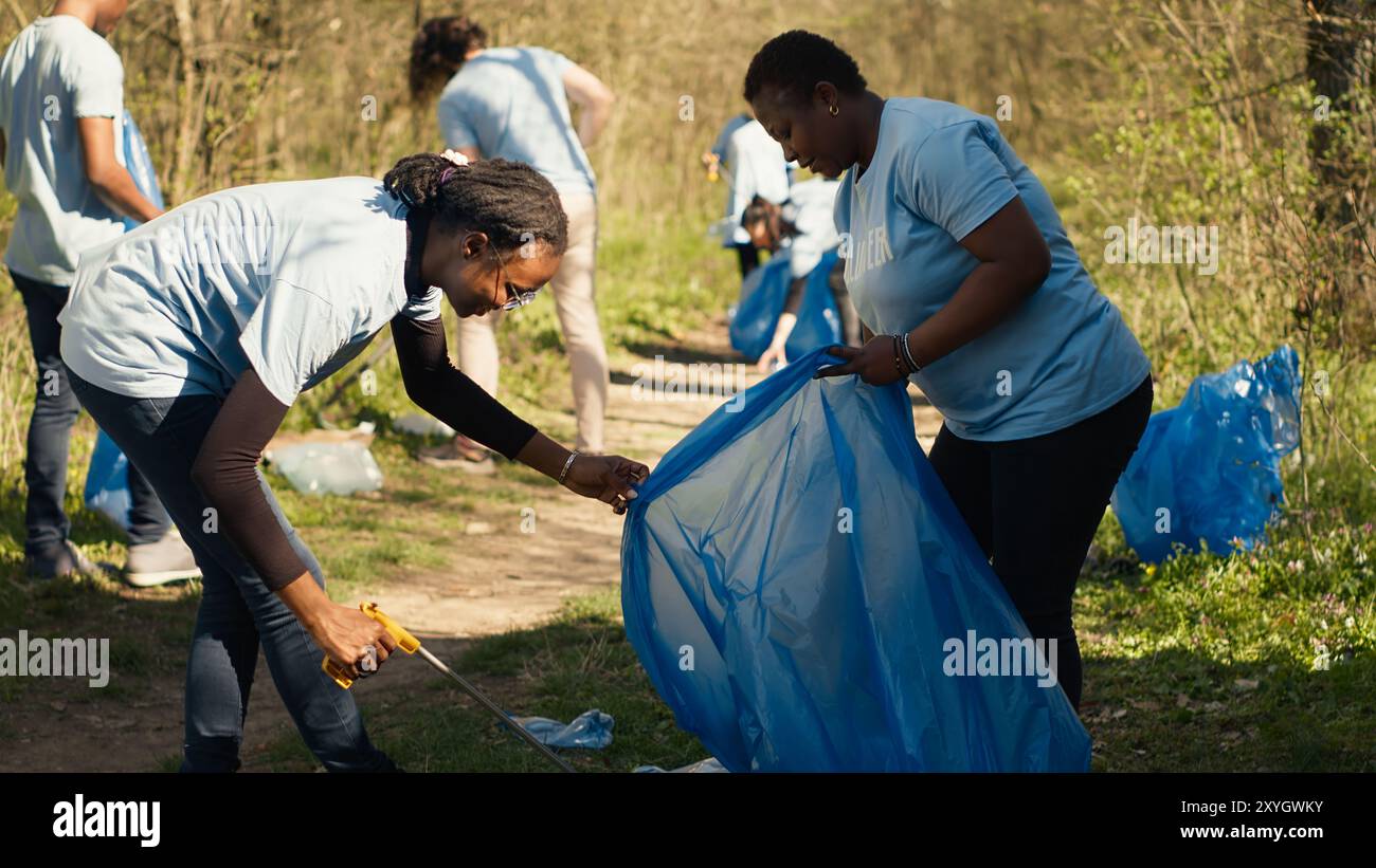 Women collecting waste in forest hi-res stock photography and images ...