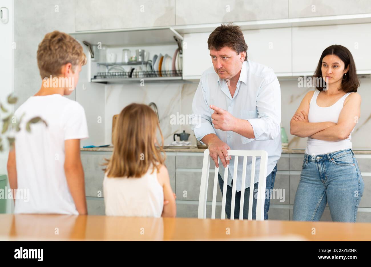 Parents scold their children in kitchen at home Stock Photo - Alamy