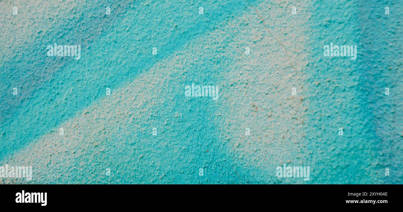 Messy blue paint spray strokes and smudges on white painted wall ...