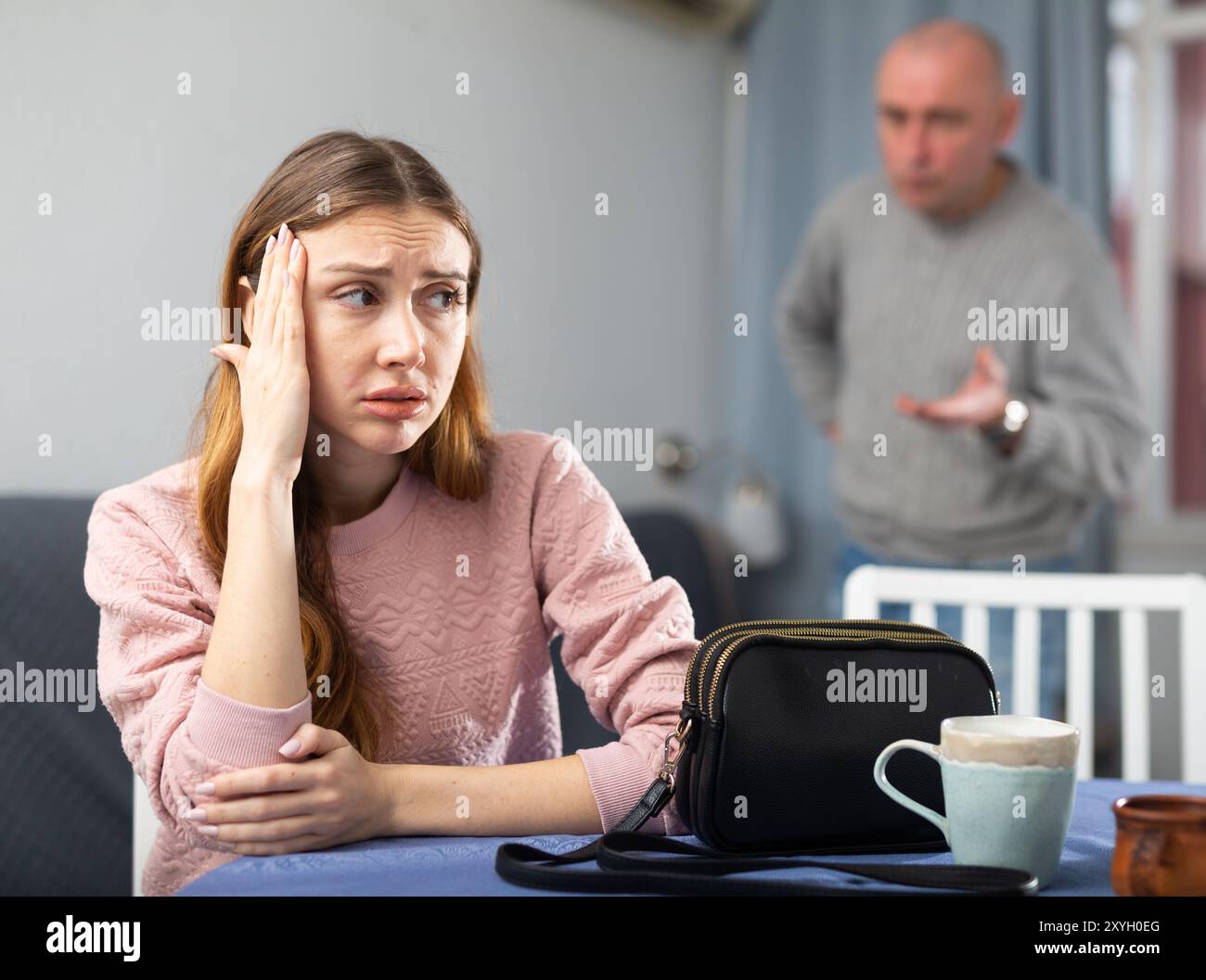 Upset woman listening her husband swearing at her Stock Photo - Alamy