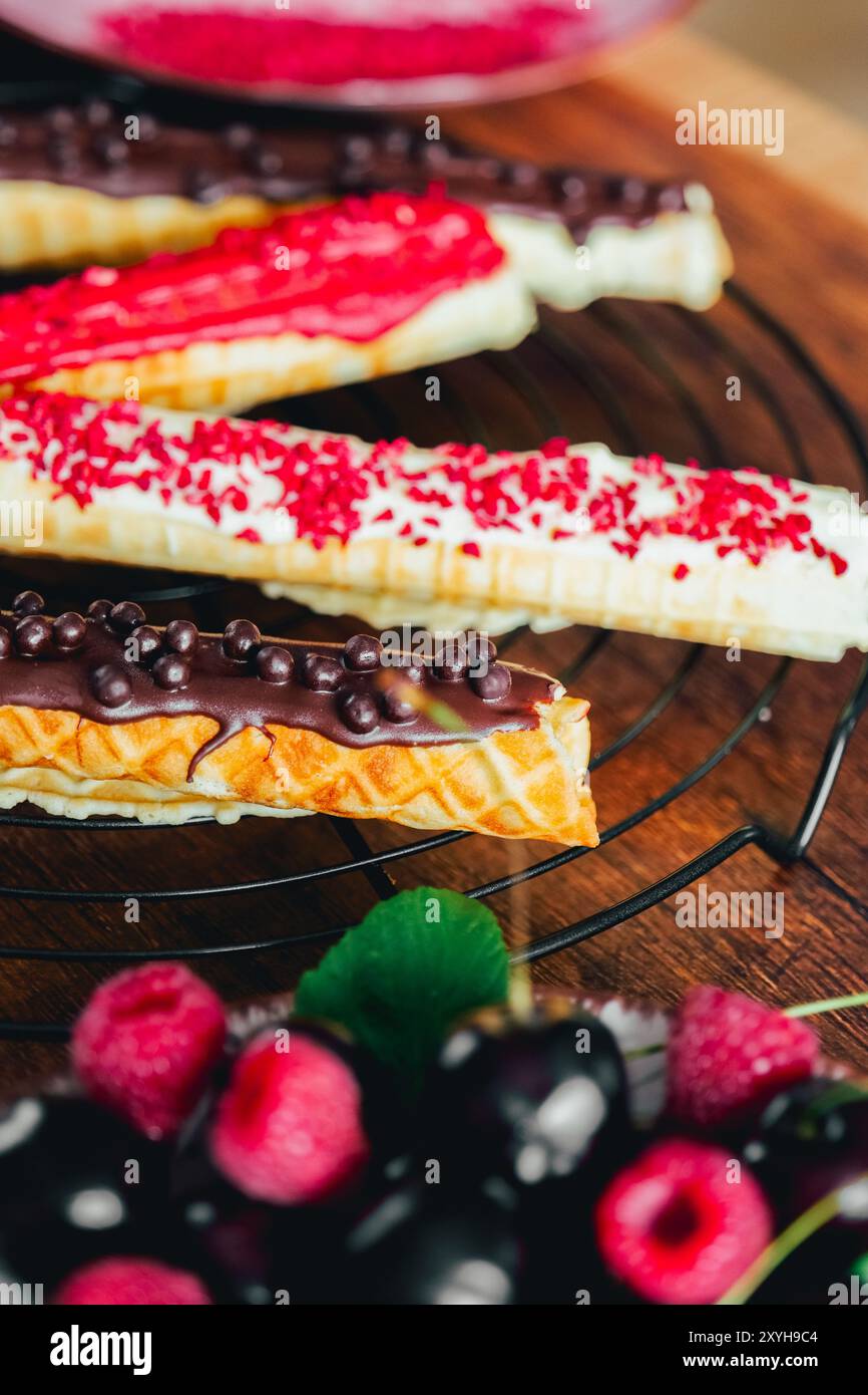 Crispy wafer tube with edible decorations. Crispy sweet dessert. Wafer ...