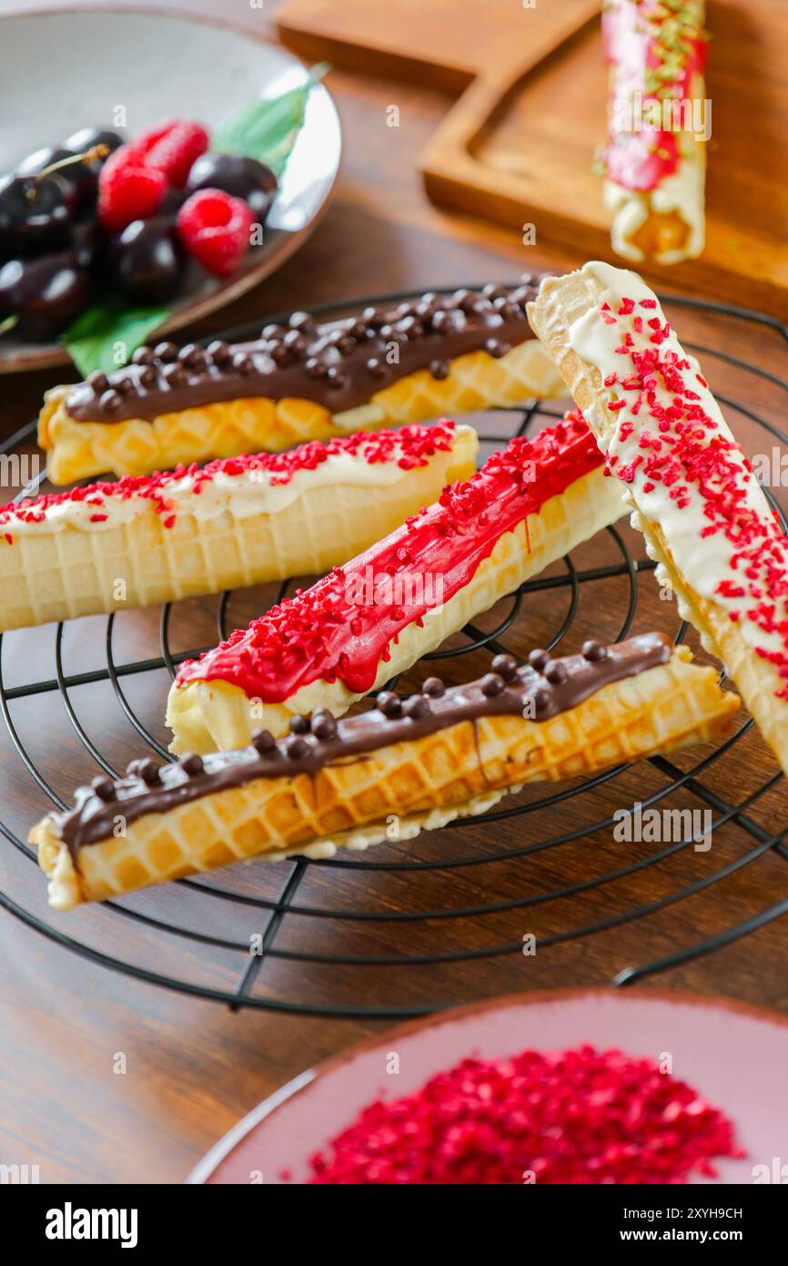 Wafer pastries on the table. Wafer rolls with dried raspberries and ...