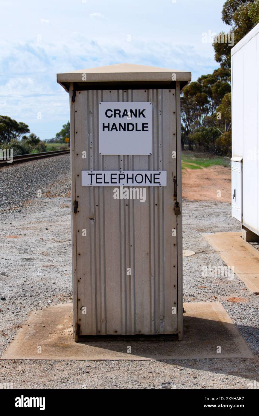 Old crank handle telephone box alongside of railway , Western Australia ...