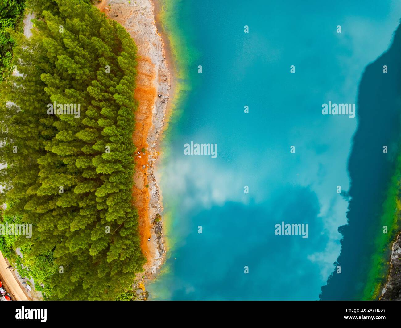 Aerial view of amazing pond in tropical rainforest with mountain rocks ...