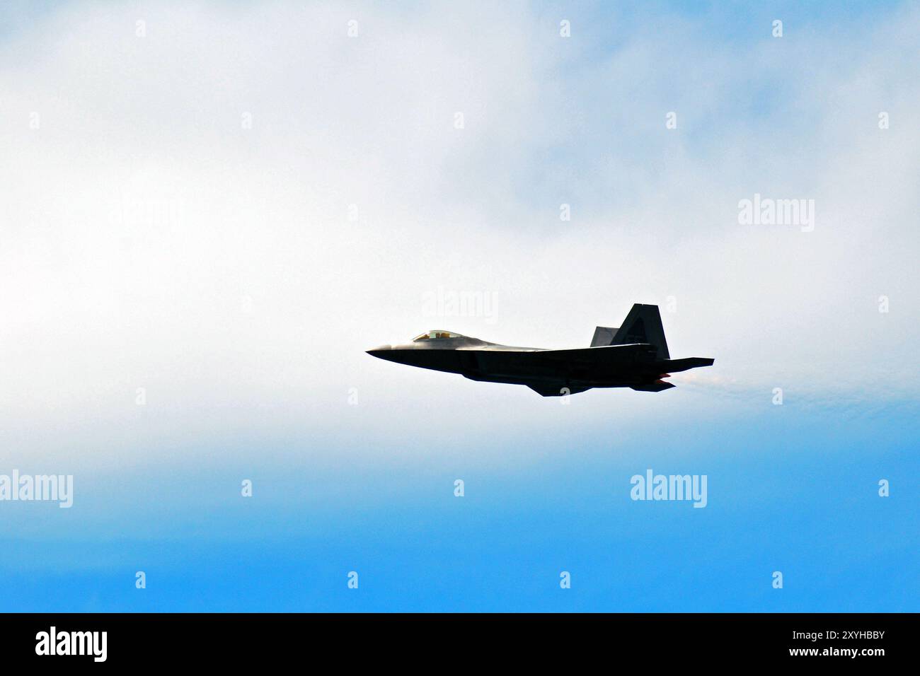 A Lockheed Martin F22 Raptor jet airplane steaks through the sky over ...
