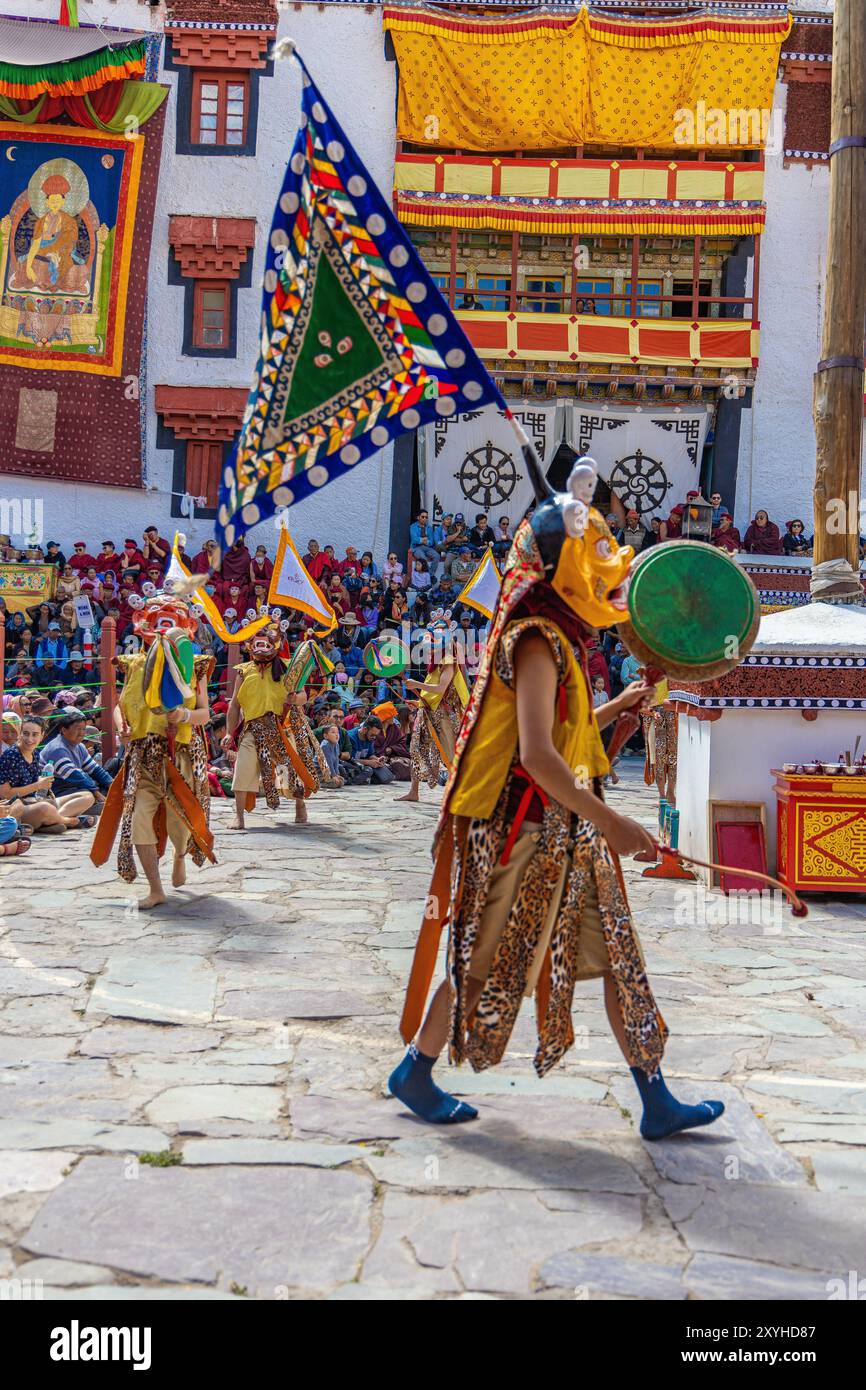 Young Buddhist monks dressed in traditional costume beating drum at ...