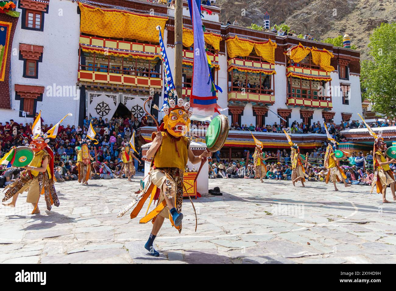 Young Buddhist monks dressed in traditional costume beating drum at ...