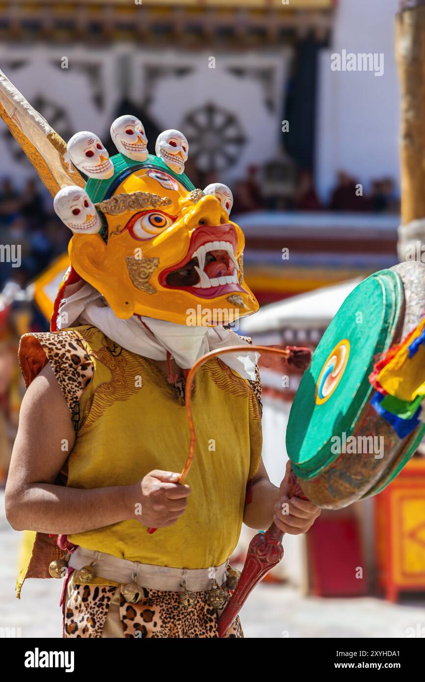 Young Buddhist monks dressed in traditional costume beating drum at ...