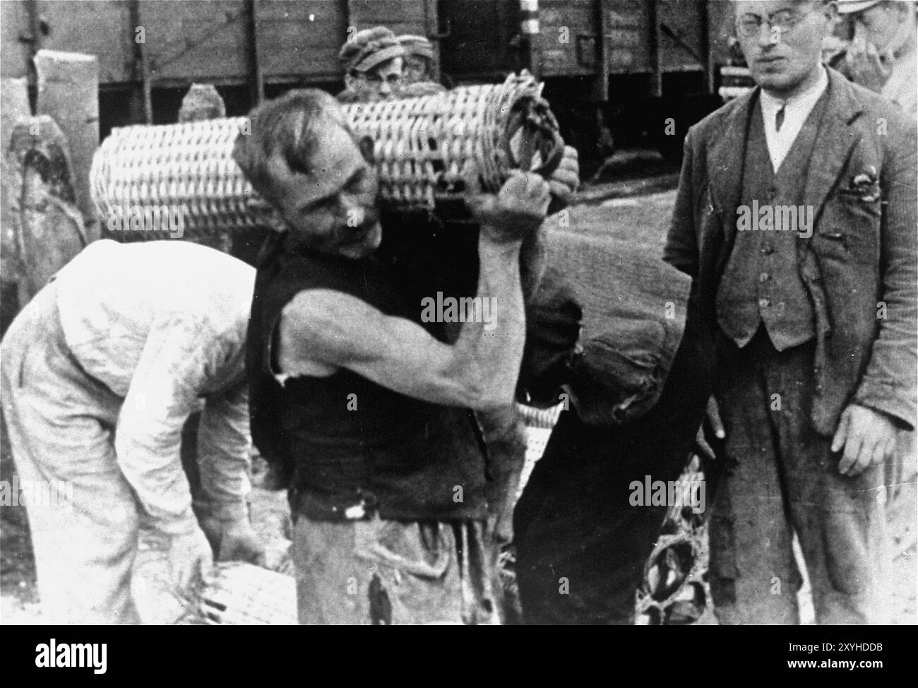 Jewish men are forced to load a German munitions train near Lublin in ...