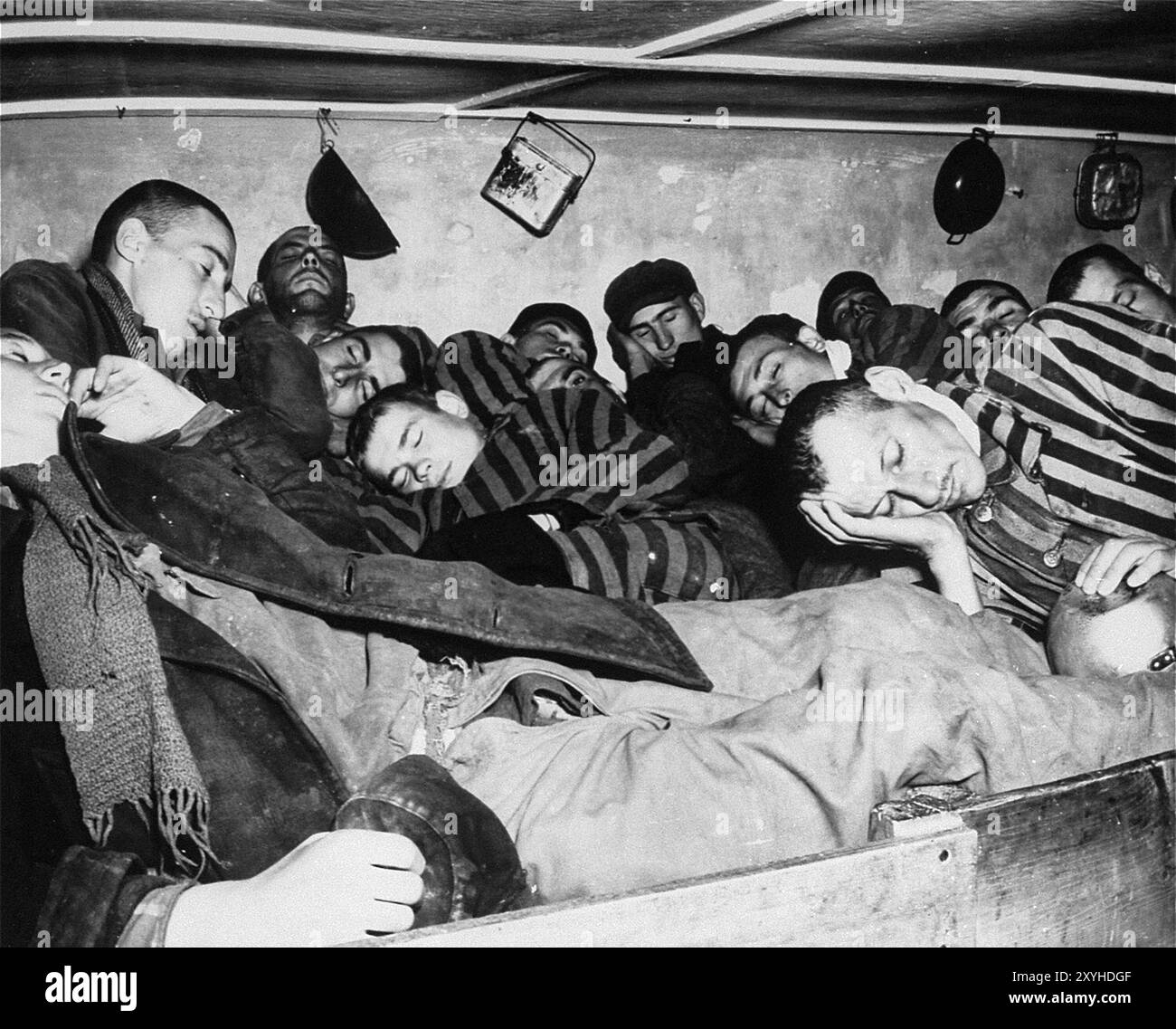 Survivors in Dachau packed into overcrowded sleeping quarters, where 7 ...