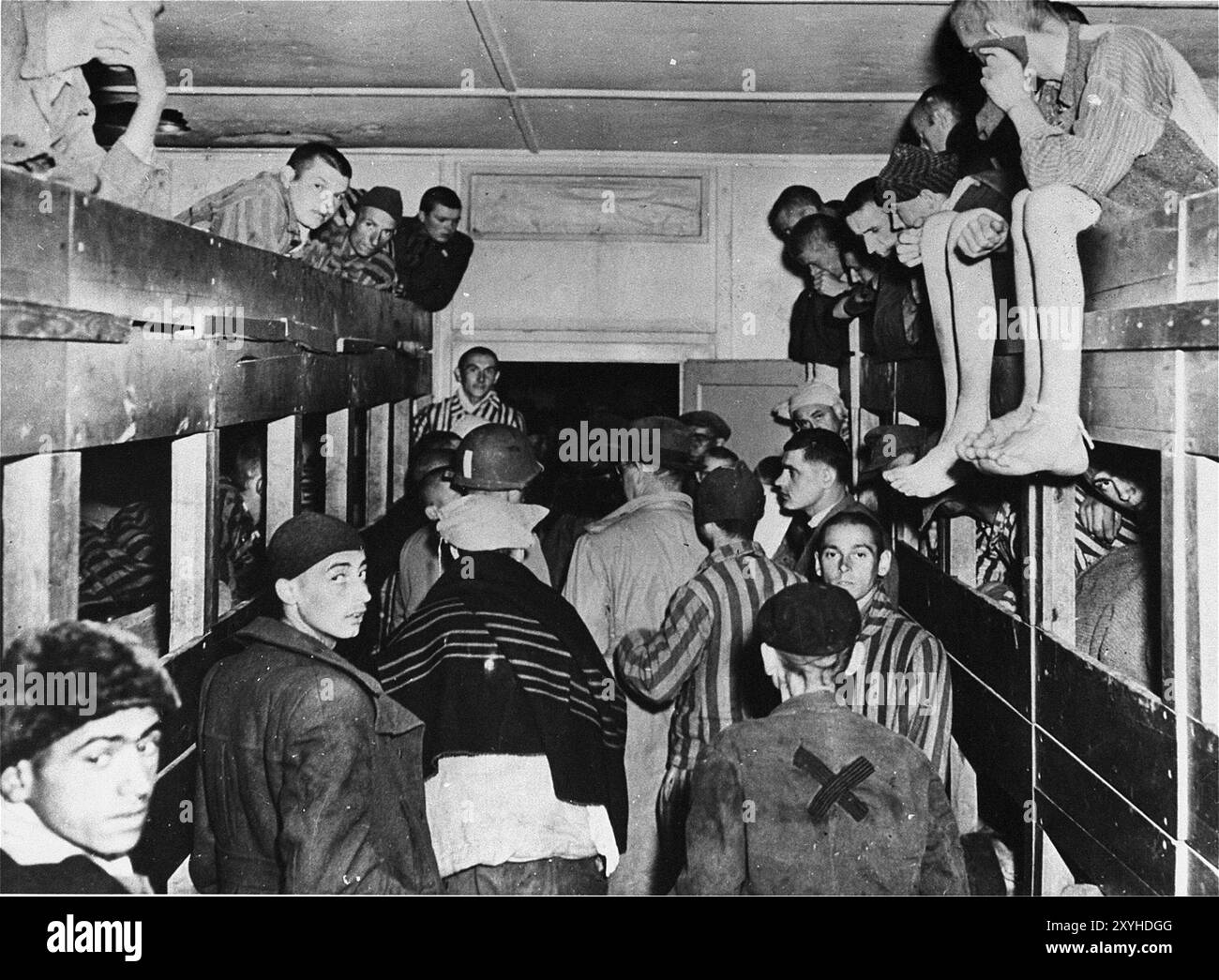 A group of survivors watching US soldiers and journalists inspecting ...