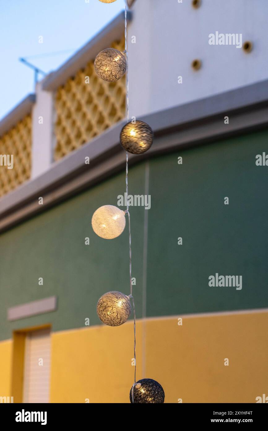Decorative hanging balls in front of bright building and window Stock ...