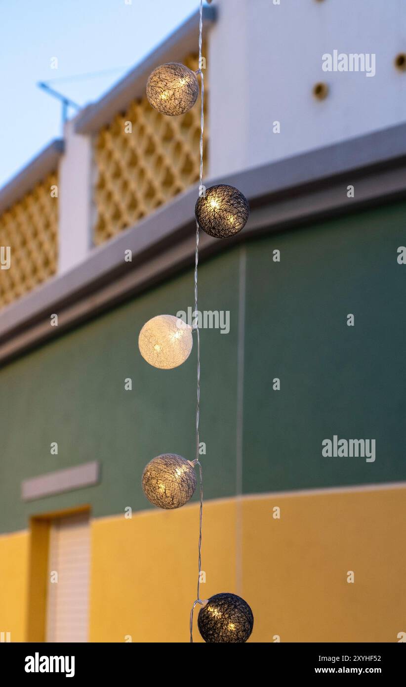 Decorative hanging balls in front of bright building and window Stock ...
