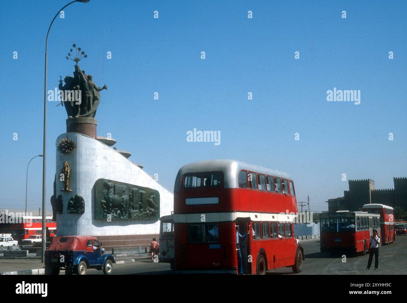 Central Baghdad with monument to the Baath Party and London red double ...