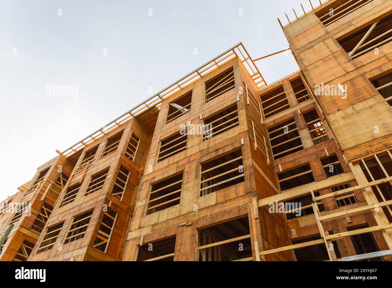 New residential construction home framing against a blue sky. Roofing ...