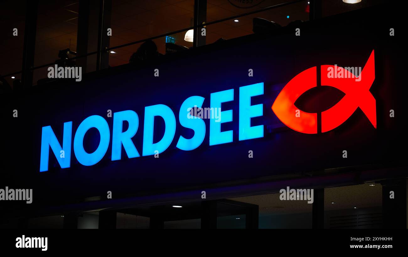 Illuminated sign for the German fast-food chain Nordsee in the evening ...