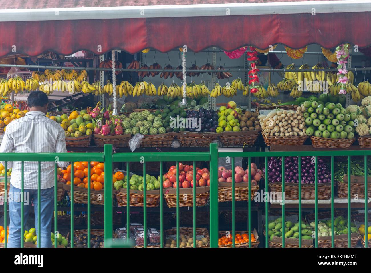 Back view of an indian man choosing fresh produce at a fruit store ...