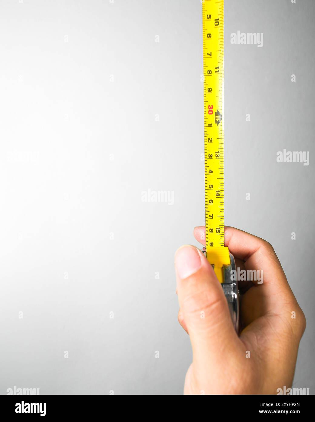 Metal measuring tape in hand with vertical copy space , Metal measuring ...