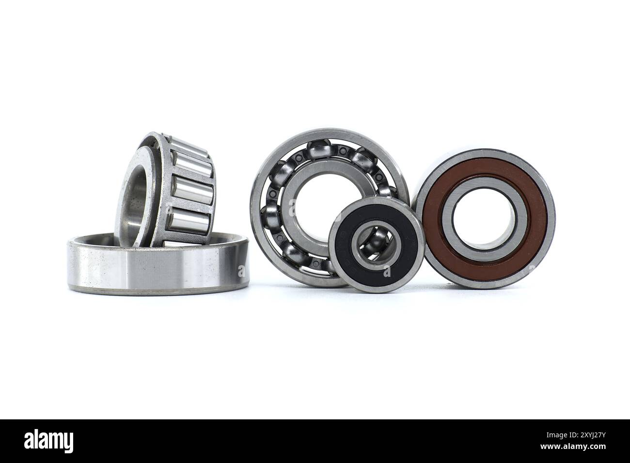 Ball bearings and tapered roller bearing isolated on white background ...
